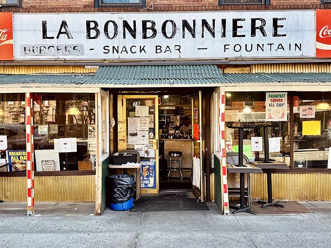 La Bonbonniere's weathered fa&ccedil;ade stands as a time capsule in the West Village, its vintage sign promising the holy trinity of comfort: burgers, snacks, and fountain treats.