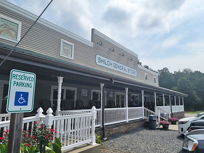 The welcoming facade of Shiloh General Store stands proudly against a brilliant blue North Carolina sky, its wide porch practically whispering "slow down and stay awhile."