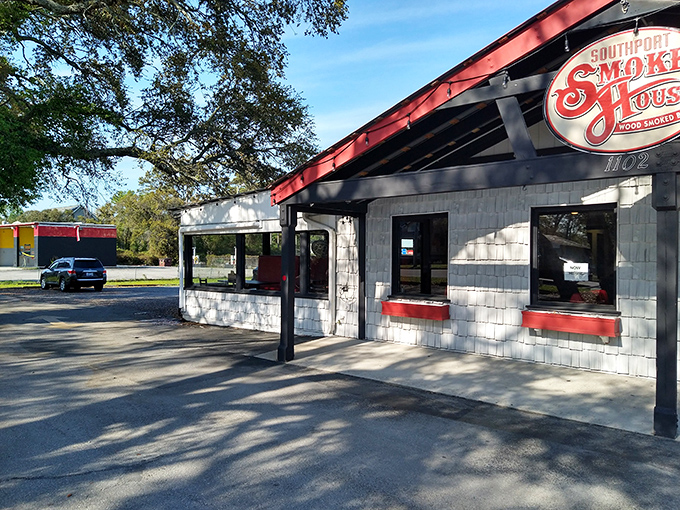 The red-roofed temple of smoke beckons with all the subtlety of a dinner bell, promising salvation through slow-cooked meats in coastal Southport. 