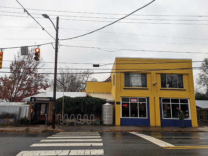 The cheerful yellow exterior of Sunny Point Cafe stands like a beacon of breakfast hope on West Asheville's bustling corridor.