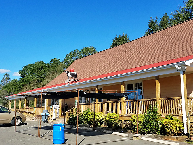 The iconic cow with a red cap stands guard atop this charming country store, promising dairy delights that are worth every mile of the journey.