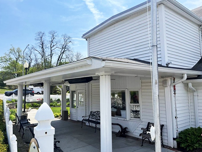 The white clapboard exterior with its American flag and welcoming porch feels like stepping into a Norman Rockwell painting of Southern hospitality. 