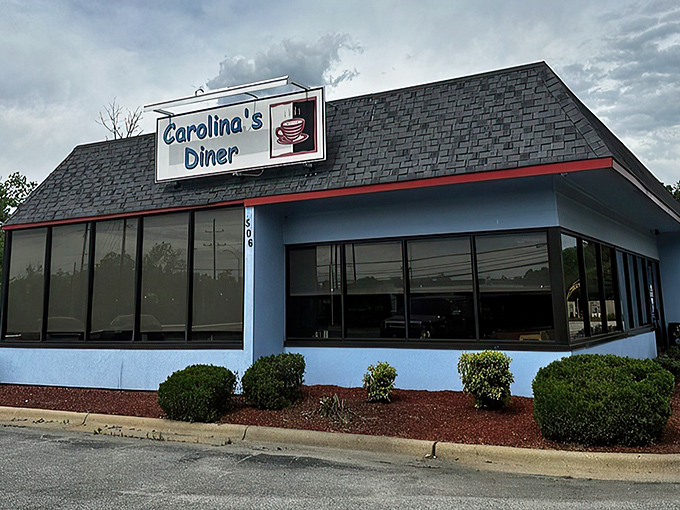 The distinctive blue exterior of Carolina's Diner stands as a beacon of breakfast hope along Regional Road, promising comfort food salvation inside. 