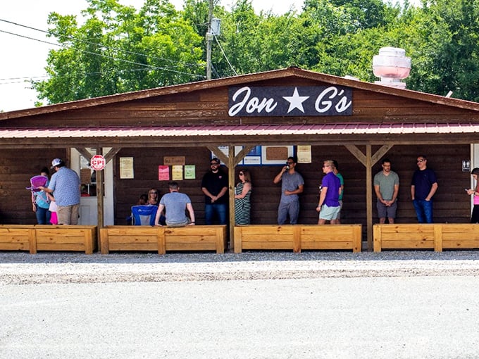 The line forms early at Jon G's rustic wooden facade, where BBQ pilgrims gather with the reverence of concert-goers awaiting a legendary headliner.