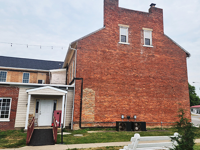 The historic facade of Red Brick Tavern stands proudly along Route 40, its weathered bricks whispering stories from nearly two centuries of serving hungry travelers.