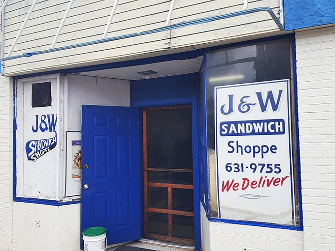 The blue door to sandwich paradise doesn't need neon signs or fancy awnings&mdash;just the promise of "We Deliver" and decades of deliciousness.