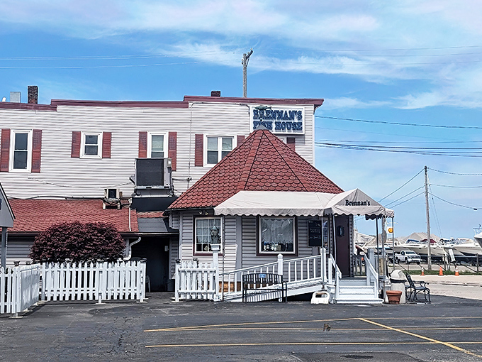 The iconic red-roofed entrance to Brennan's Fish House stands like a lighthouse beacon for hungry travelers. Seafood salvation awaits inside.