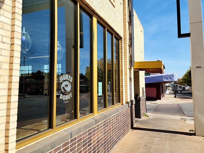 The unassuming brick exterior of Hurts Donut Company hides a kaleidoscope of sugary treasures within. Yellow trim hints at the colorful experience awaiting inside.