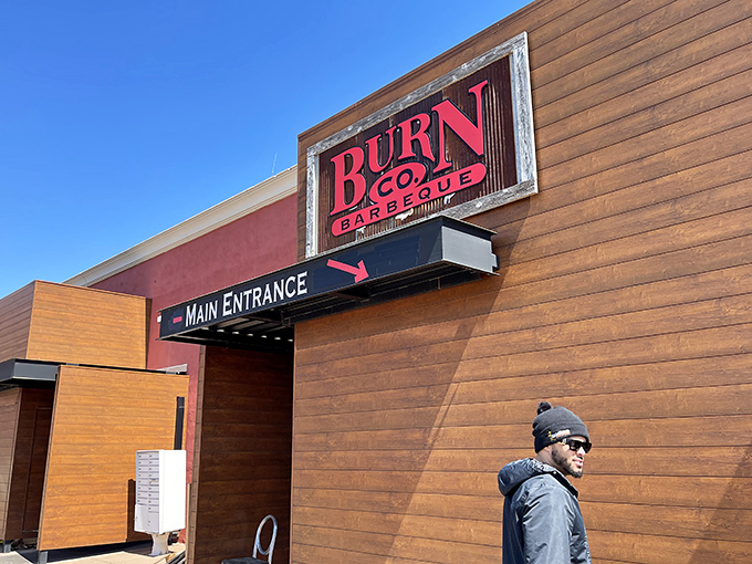 The wooden facade of barbecue paradise beckons with its bold red sign &ndash; a siren call to meat lovers that promises smoky delights within.