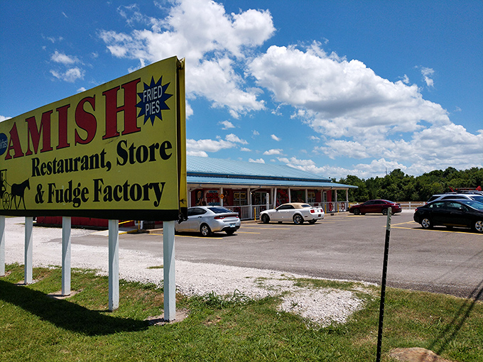 The unassuming burgundy exterior with its "Try our Amish Butter and Cheeses" sign promises treasures within that the simple facade modestly conceals.