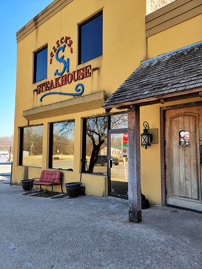 The bright yellow exterior of Click's Steakhouse stands like a beacon of carnivorous delight in Pawnee, promising beef-based bliss to those wise enough to make the journey.