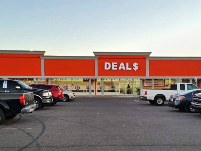 The bright red storefront of Deals Outlet Bin Store stands out like a beacon of bargain hope on SW 59th Street. Treasure hunting begins here!