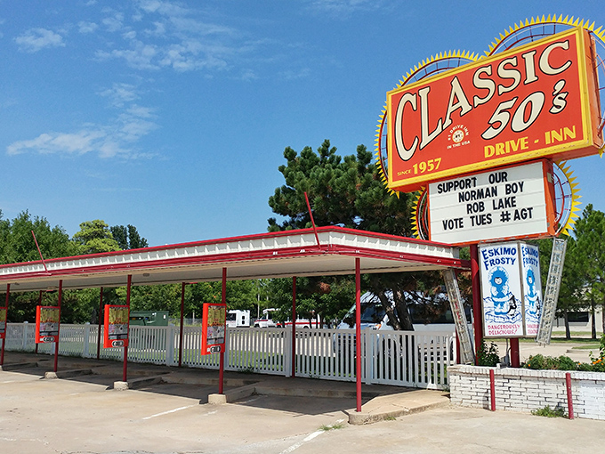 That iconic sunburst sign isn't just advertising&mdash;it's a time machine disguised as a drive-in. The red and white awning beckons like a burger beacon on the horizon.