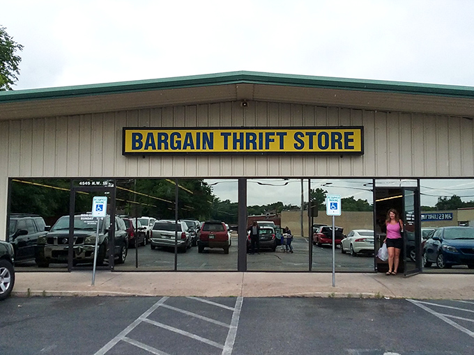 The unassuming exterior of Bargain Thrift Store stands like a vault of hidden treasures, its yellow sign a beacon to bargain hunters across Oklahoma City.