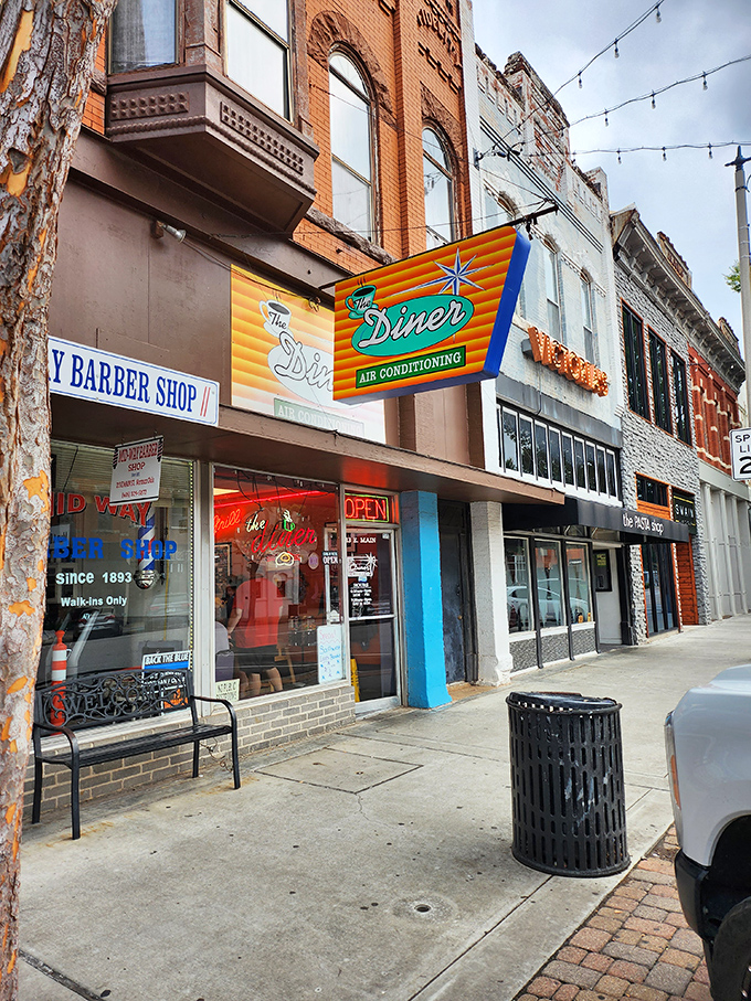 The Diner's vintage neon sign promises "AIR CONDITIONING" like it's 1955, a glowing beacon of breakfast hope on Norman's Main Street.