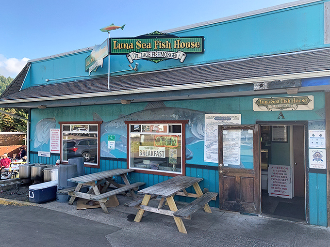 The turquoise beacon of Luna Sea Fish House stands out against Oregon's moody skies, promising seafood salvation to hungry coastal travelers.
