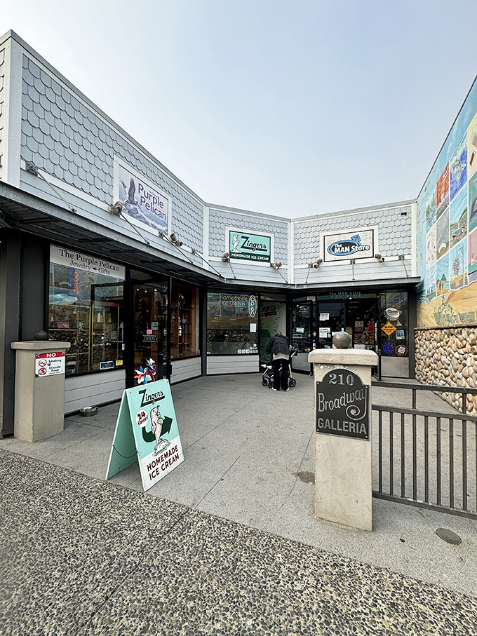 The iconic blue-shingled exterior of Zingers stands like a beacon of sweet promises on Seaside's Broadway Street, complete with their playful sea lion mascot. 