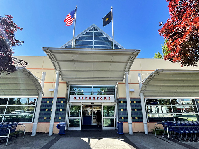 The iconic triangular entrance to Goodwill's Portland superstore stands like a beacon for treasure hunters, promising adventures in secondhand shopping beneath those blue letters. 