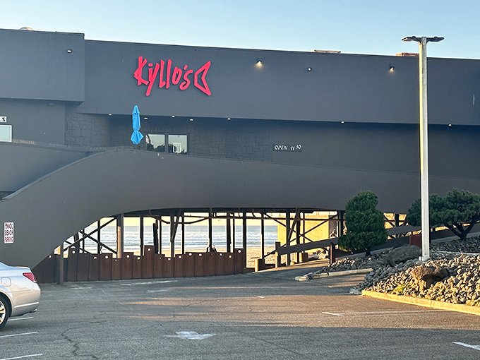 Kyllo's distinctive exterior stands like a modern lighthouse above the beach, beckoning hungry travelers with its glowing red sign.