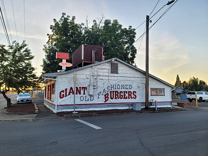 The unassuming white clapboard exterior of Giant Burger stands like a time capsule, its bold red sign promising exactly what generations of Oregonians have come to crave. 