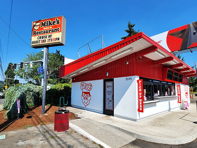 The iconic red and white exterior of Mike's Drive-In stands as a beacon of burger perfection in Milwaukie, welcoming hungry visitors with retro charm. 