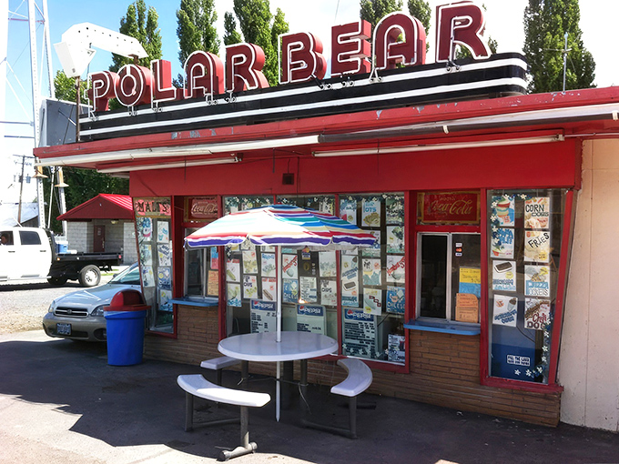 The iconic Polar Bear stands proudly against Merrill's water tower, its vintage neon sign promising cold treats in a warm welcome.