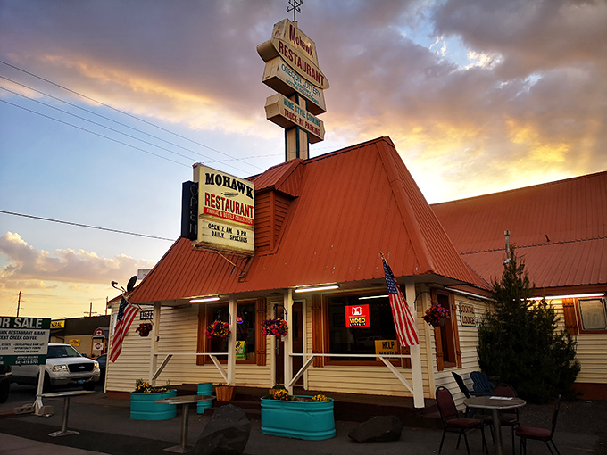 The copper-topped A-frame roof of Mohawk Restaurant stands like a rustic beacon for hungry travelers on Highway 97, complete with patriotic flair. 