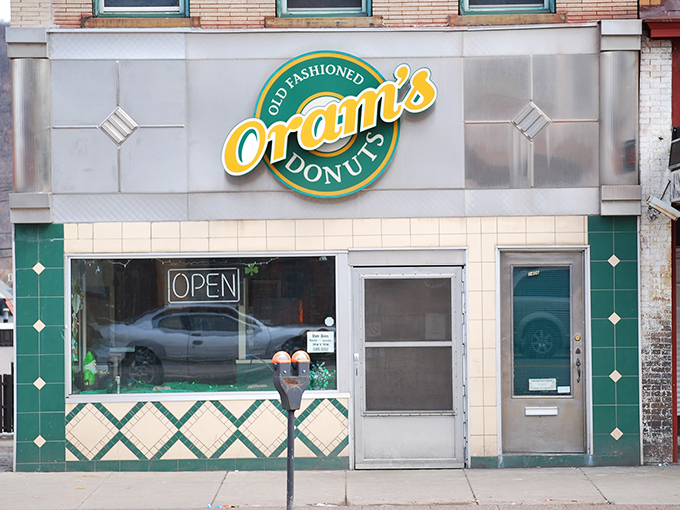 The green and gold storefront beckons like a lighthouse for the sugar-deprived. Since 1938, this humble facade has witnessed countless donut pilgrimages.