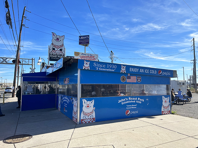 The iconic blue exterior with its cheerful pig mascot stands as a beacon of sandwich excellence in South Philly's industrial landscape. 