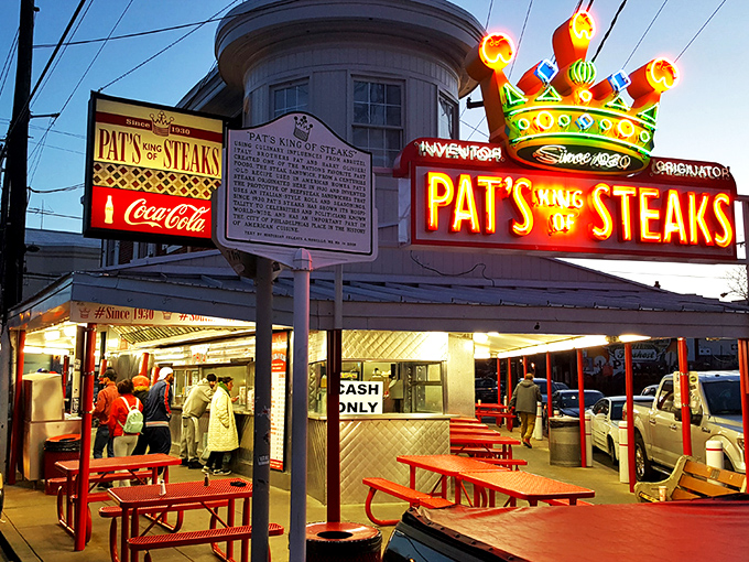 The brick-and-mortar kingdom where cheesesteak dreams come true since 1930. Pat's iconic red and white facade has witnessed nine decades of sandwich perfection.
