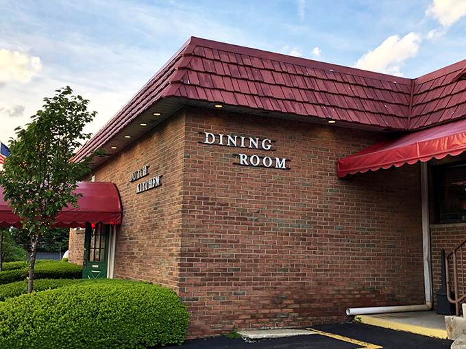 The iconic red-roofed Dutch Kitchen stands like a beacon of comfort food promise, complete with spring tulips that seem to bow in culinary reverence.