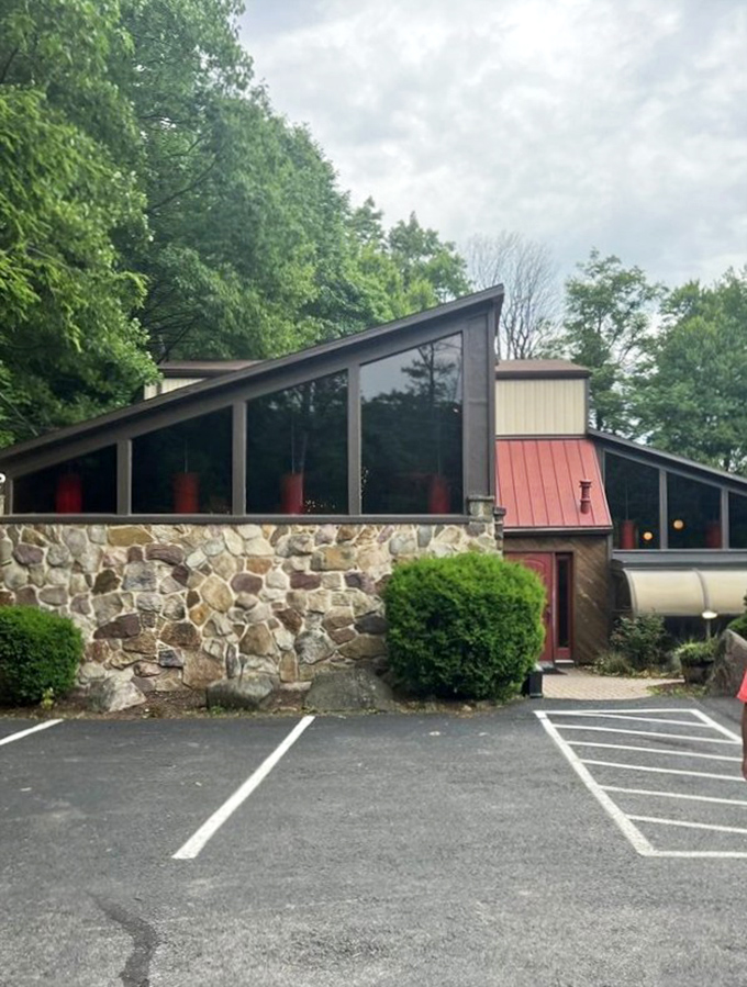 The forest parts to reveal culinary treasure – Louie's Prime Steak House stands proudly among the trees, its stone foundation and wooden charm beckoning hungry travelers.
