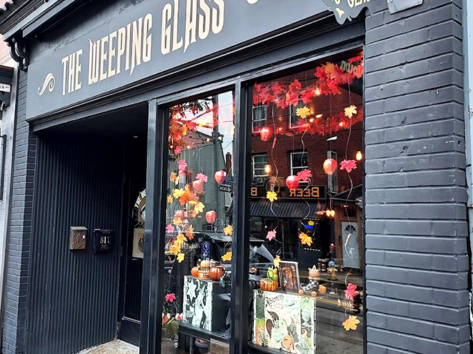 The Weeping Glass beckons curious passersby with gold lettering that promises "ODDITIES" and "CURIOSITIES" &ndash; an invitation few can resist.