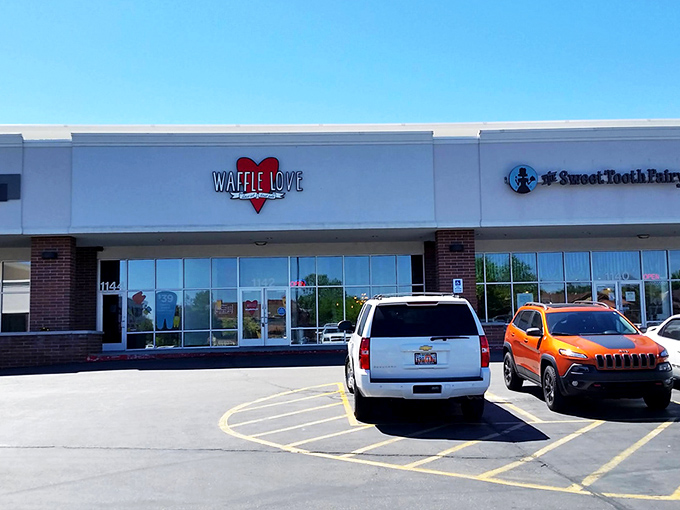 The bright red heart logo of Waffle Love beckons from the storefront like a siren song for breakfast enthusiasts. Your waffle journey begins here.