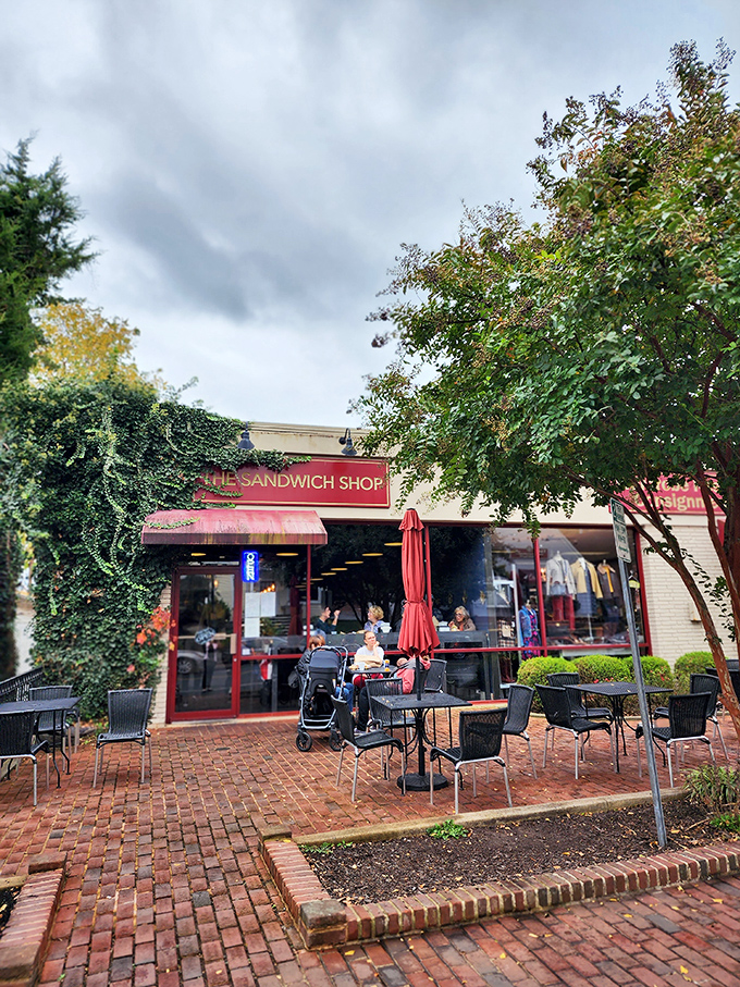The red-framed storefront of The Sandwich Shop beckons like a beacon of lunch salvation, complete with charming brick patio seating under Vienna's leafy canopy.