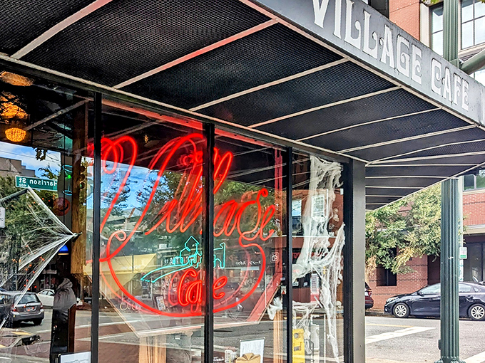 That iconic neon sign beckons like an old friend through the window. Village Cafe's exterior promises authentic diner magic without a hint of pretension.