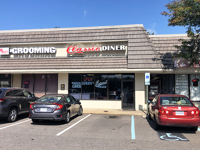 The shingled exterior of Classic Diner beckons with its bold red script and neon promise of daily breakfast. Some buildings just look like they know how to feed you right.