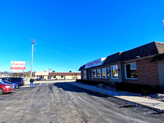 The unassuming exterior of The Pancake Place stands like a breakfast lighthouse, beckoning hungry travelers through Green Bay's morning fog with promises of pancake perfection.