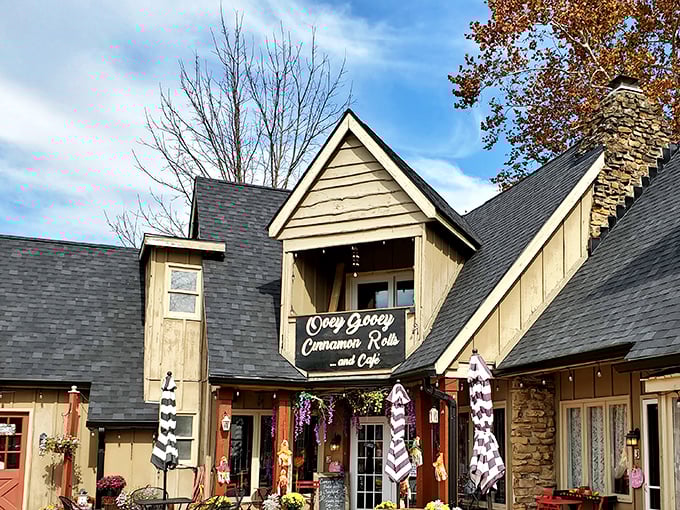 The charming cottage-style exterior of OoeyGooey beckons with bright red umbrellas and rustic wooden tables, promising sweet treasures within.