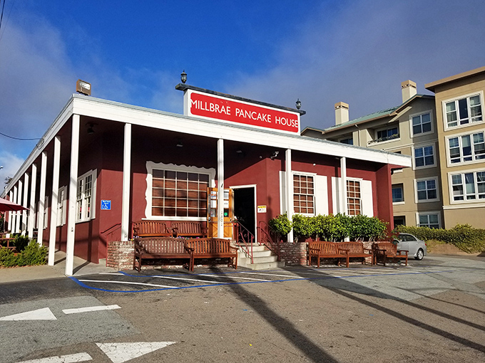 The iconic red sign beckons like a lighthouse for breakfast lovers. This unassuming burgundy building has launched a thousand food comas.