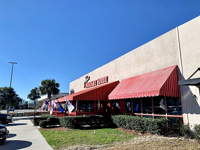 The iconic red awning beckons breakfast enthusiasts like a pancake lighthouse on the shores of morning hunger. A sight for sore, sleepy eyes!