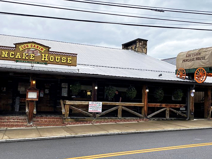 The iconic covered wagon sign welcomes hungry travelers like a beacon of breakfast hope on Gatlinburg's bustling parkway.