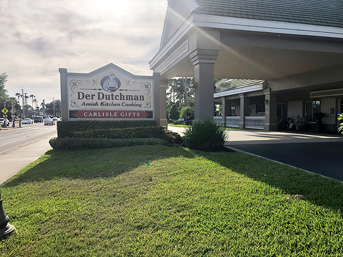 Where Amish tradition meets Florida sunshine. The green-roofed farmhouse style of Der Dutchman creates an unexpected oasis amid swaying palm trees.