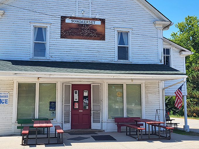 The white clapboard exterior with its cherry-red door isn't trying to impress anyone, which is exactly why it's so impressive. Small-town Kansas perfection.