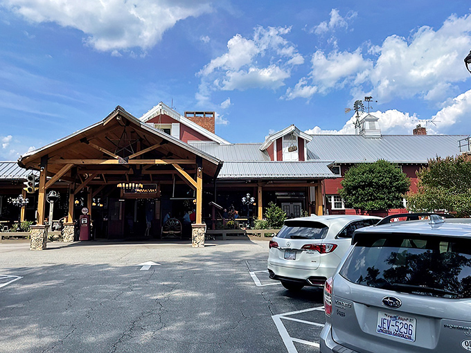 The iconic red exterior of Angus Barn welcomes diners like an old friend, its rustic charm and spacious porch promising memorable meals and Southern hospitality. 