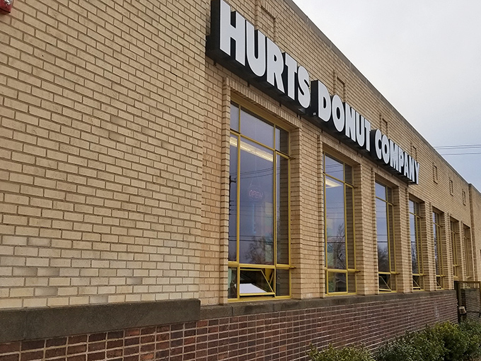 The unassuming brick exterior of Hurts Donut Company hides a kaleidoscope of sugary treasures within. Yellow trim hints at the colorful experience awaiting inside.