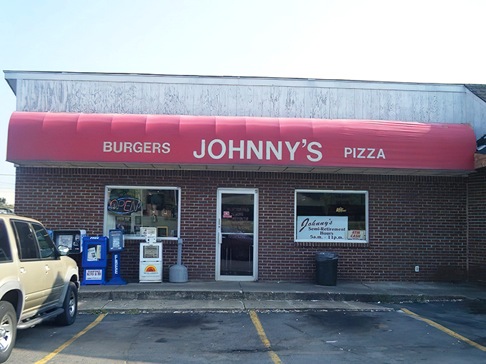 The iconic red awning of Johnny's Big Burger glows like a beacon for hungry travelers. This unassuming brick building houses burger greatness that locals have treasured for decades.