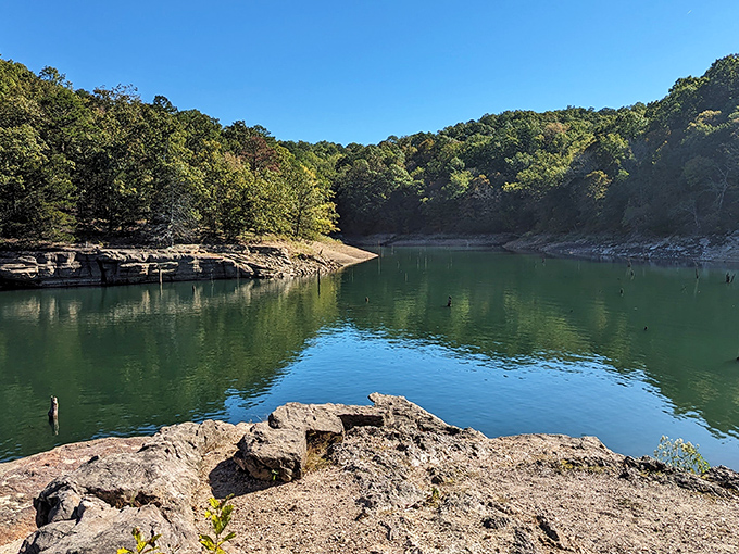 Nature's mirror game is unbeatable here, where autumn-painted limestone bluffs create perfect reflections in waters so clear you'll question which way is up.