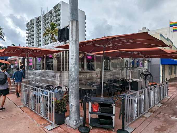 The gleaming stainless steel exterior of 11th Street Diner shines like a time machine in the Miami sun, complete with neon promises of milkshakes that'll make your inner teenager do cartwheels.