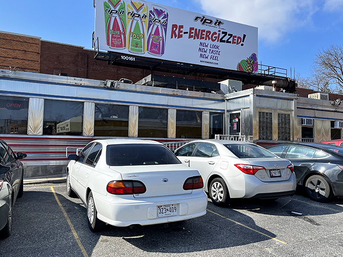 The gleaming stainless steel exterior of Overlea Diner shines like a time machine to the 1950s, complete with those iconic red stripes that practically scream "Come eat with us!"